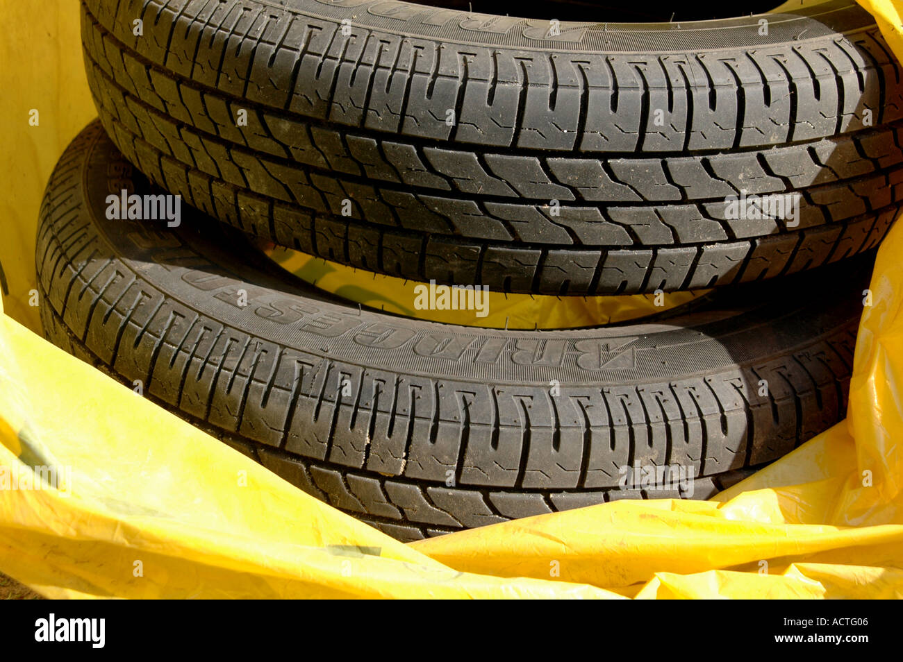Two tyres in yellow bag Stock Photo - Alamy