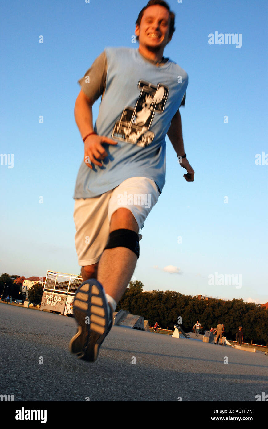Young men running Stock Photo - Alamy