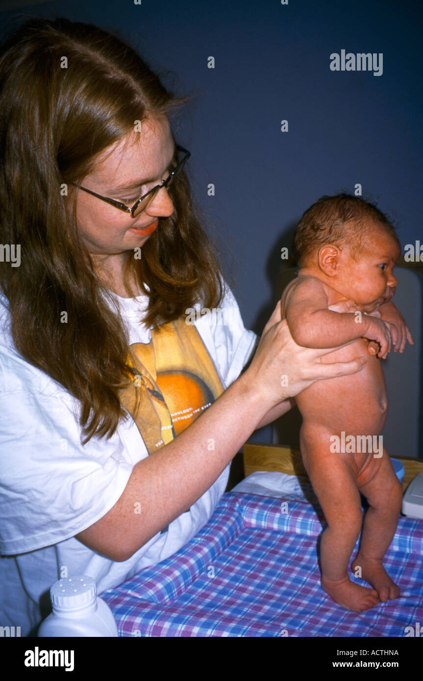 Mother Holding Baby showing Stepping Reflex Stock Photo - Alamy