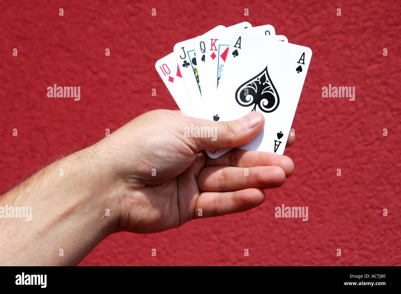 Hand holding playing cards Stock Photo - Alamy