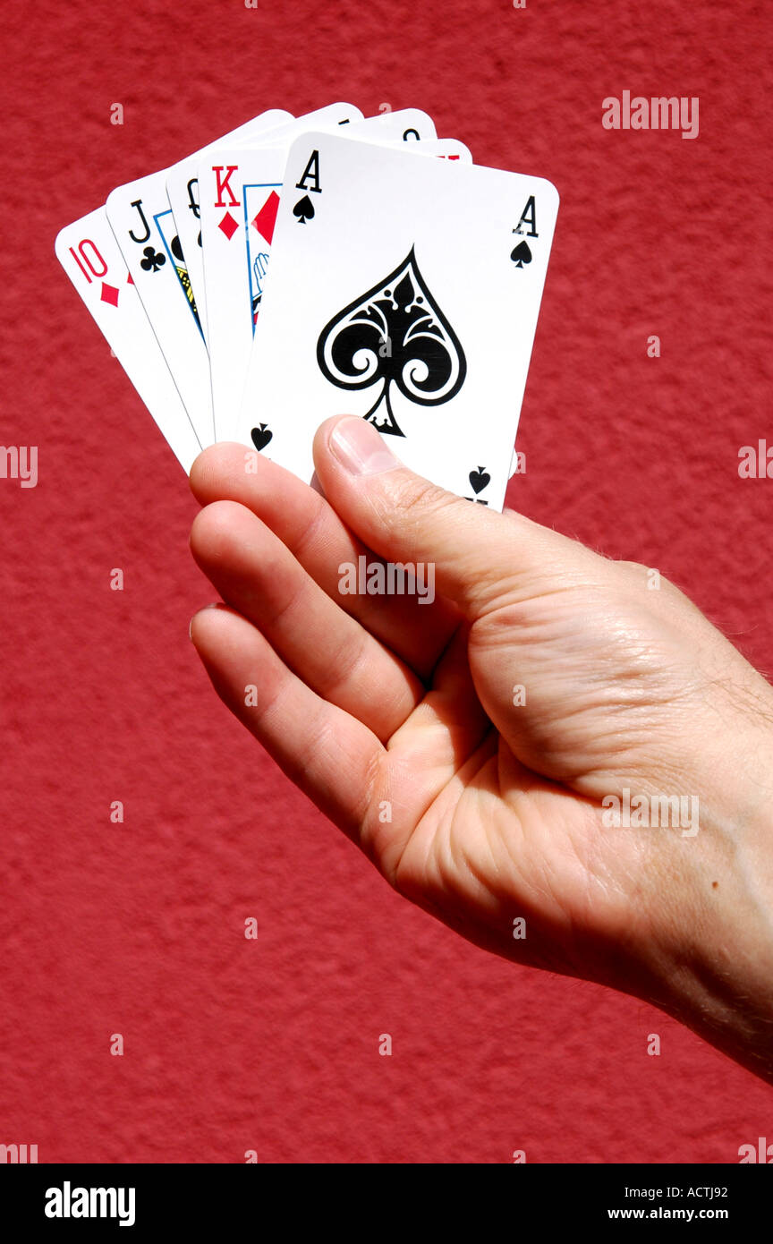 Hand holding playing cards Stock Photo - Alamy