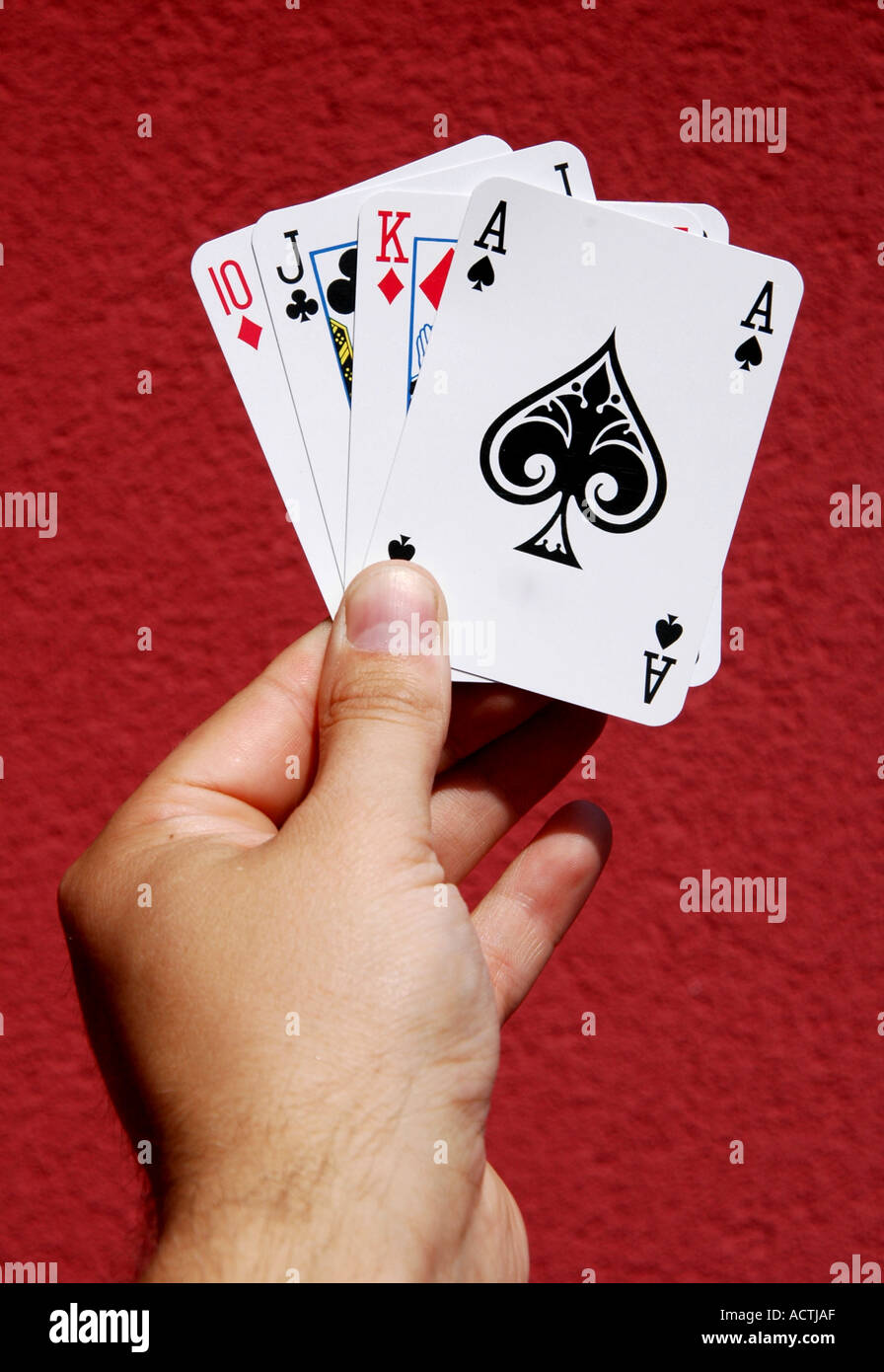 Hand holding playing cards Stock Photo - Alamy