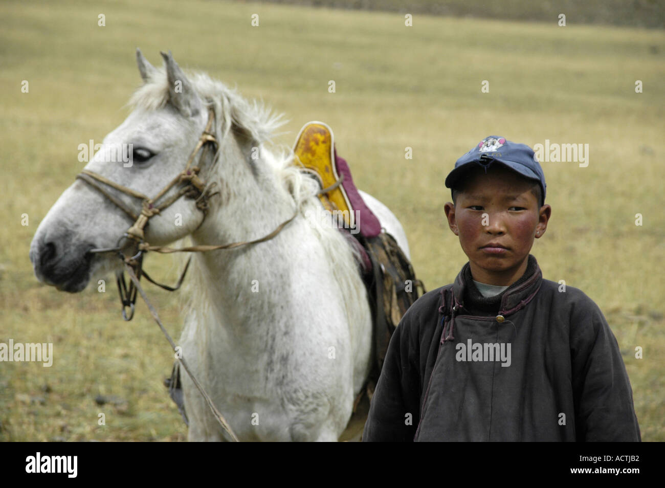 Portrait nomads shepherd boy dressed in traditional coat and cap is ...