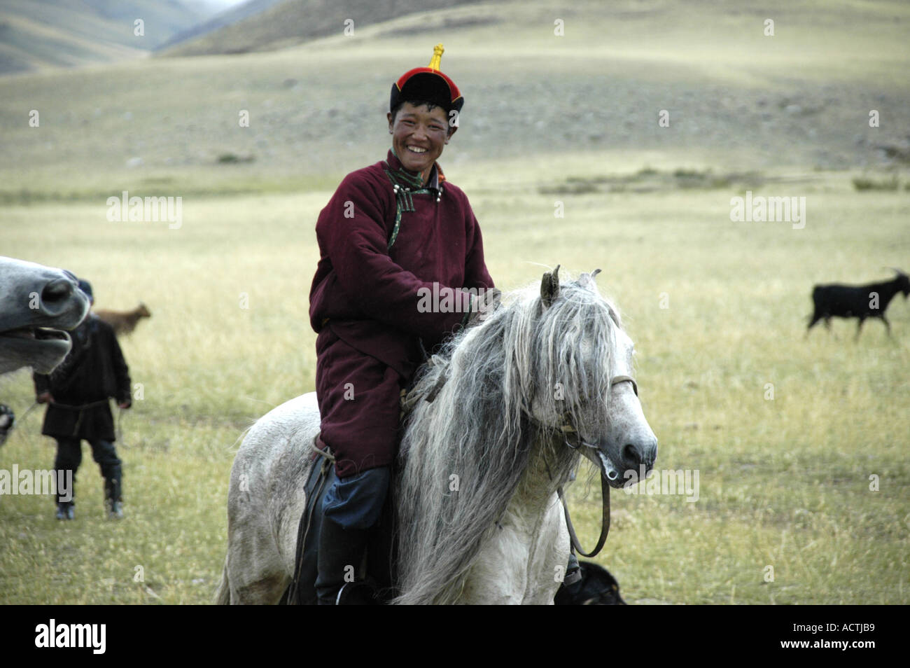 Nomads shepherd boy dressed in traditional coat and hat is riding his ...