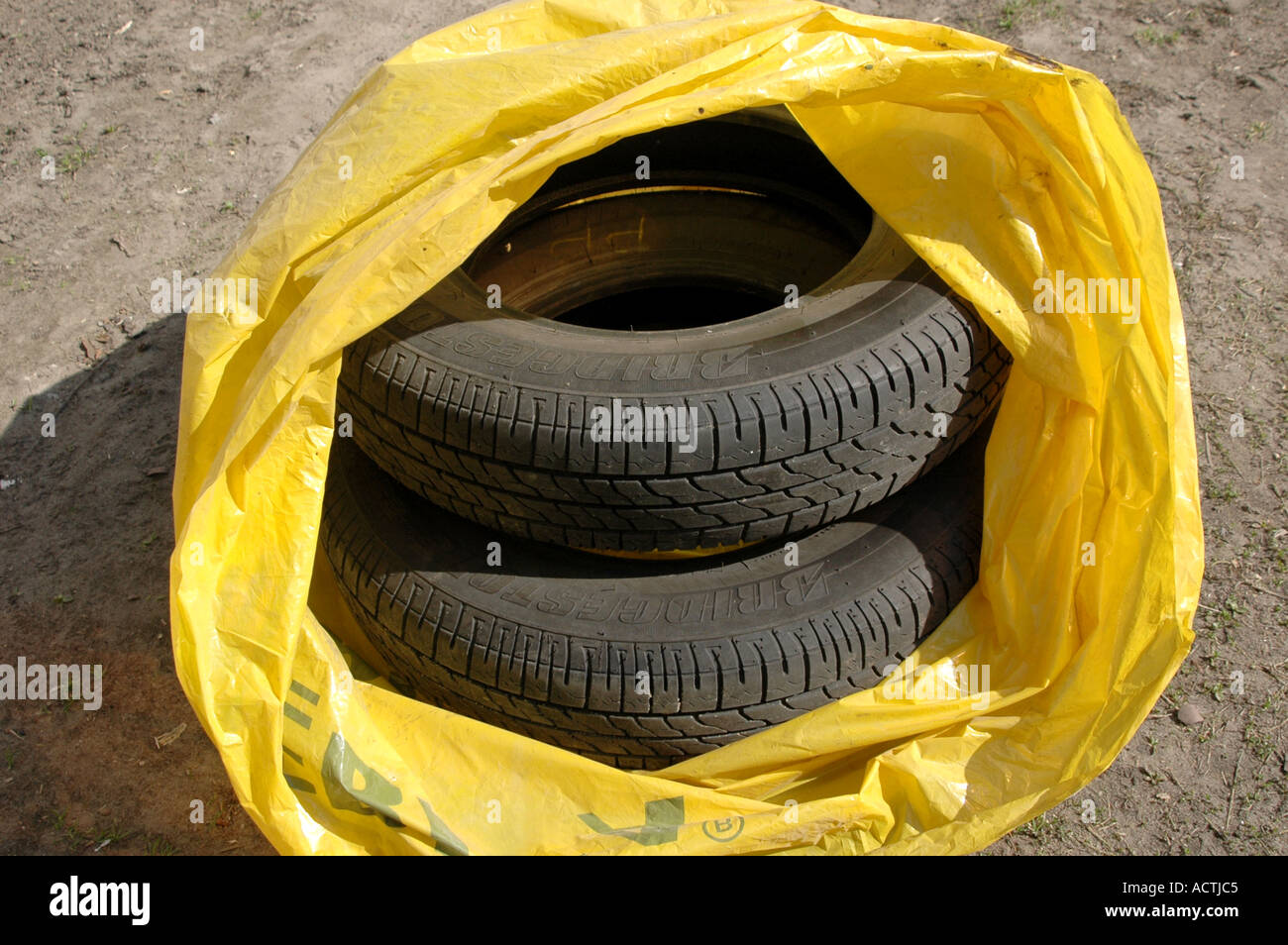 Two tyres in yellow bag Stock Photo - Alamy
