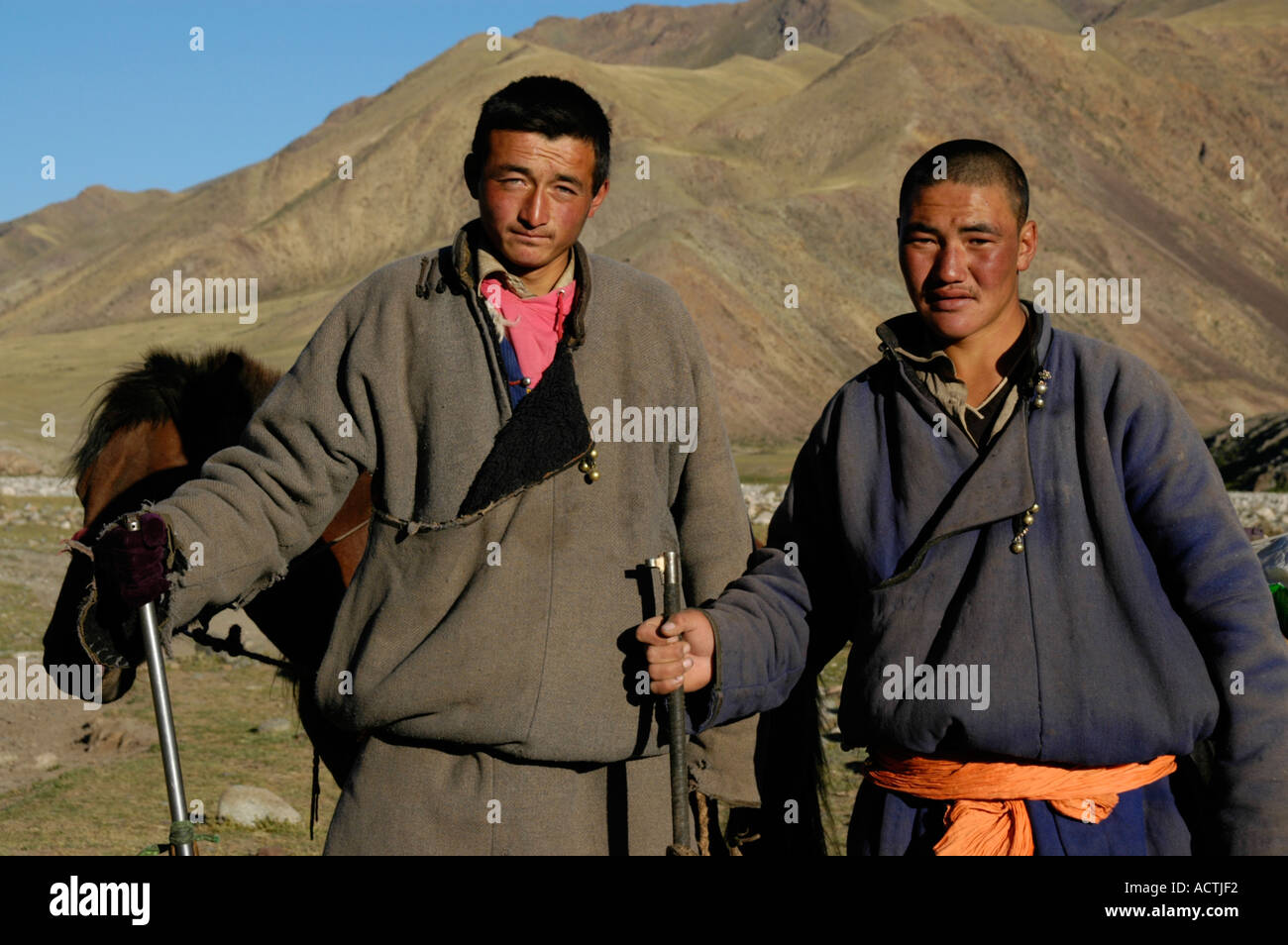 Nomads young men dressed in traditional coats with guns are standing in ...