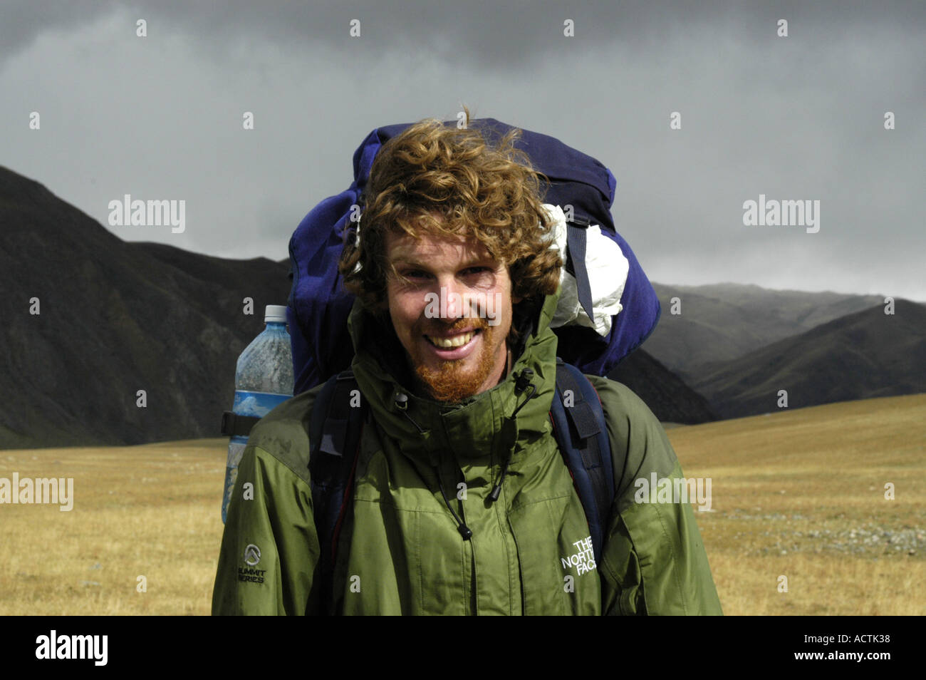 MR Portrait Trekking mountaineer with his backpack in the steppe ...