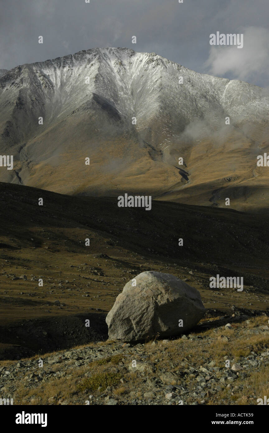 Fresh snow on a mountain light and shadow rock in the steppe Kharkhiraa ...