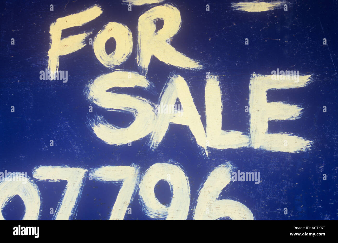 Sign painted in cream directly onto dark blue background freehand but ...