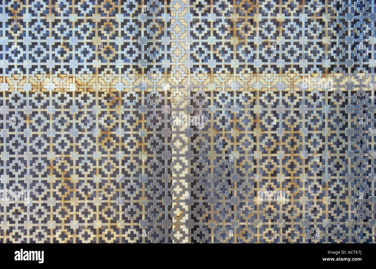 Detail of intricately cut metal screen silver but with some rust stains ...