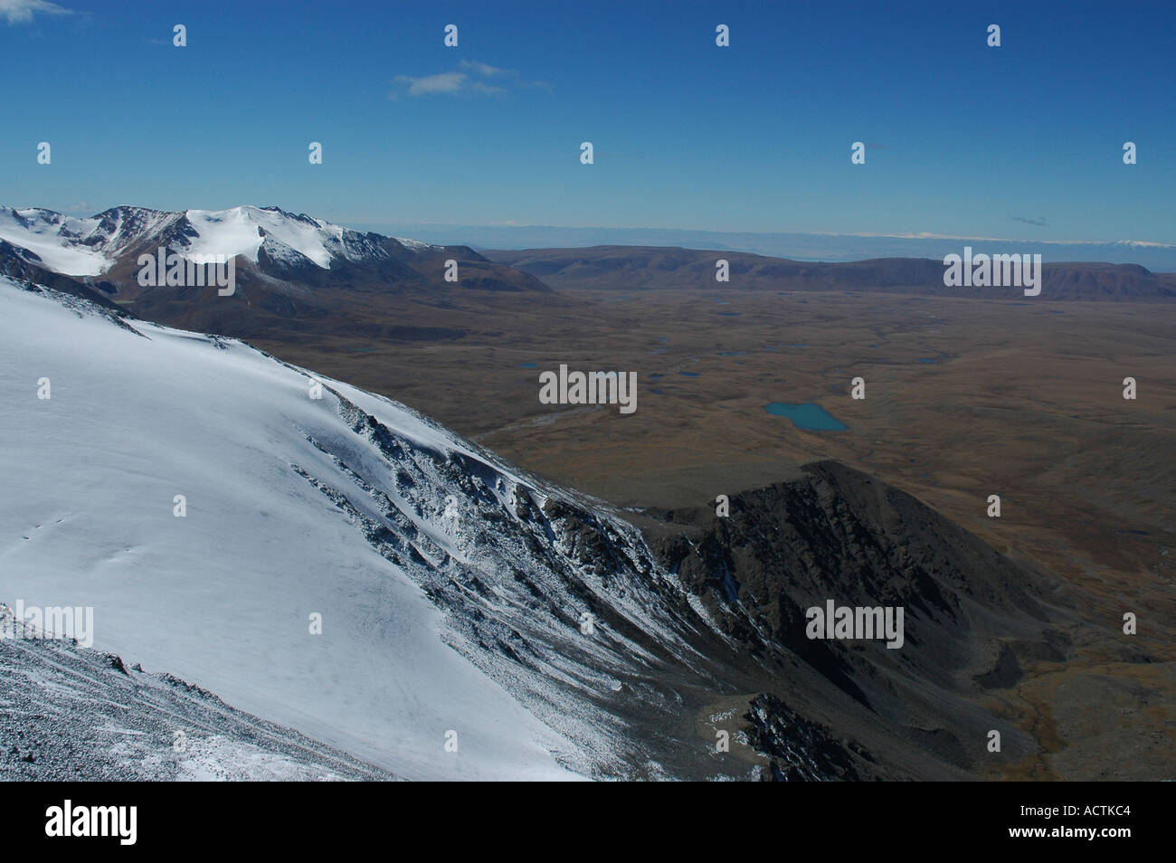 Snow covered mountain chain with wide open steppe Kharkhiraa Mongolian Altai near Ulaangom Uvs ...