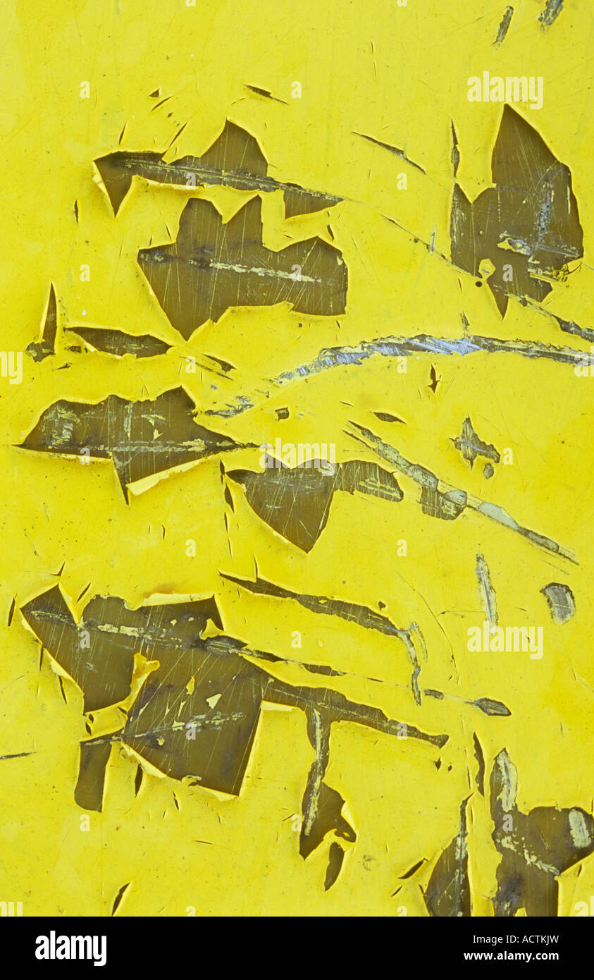 Close up of weathered and flaking and scratched yellow paint revealing ...