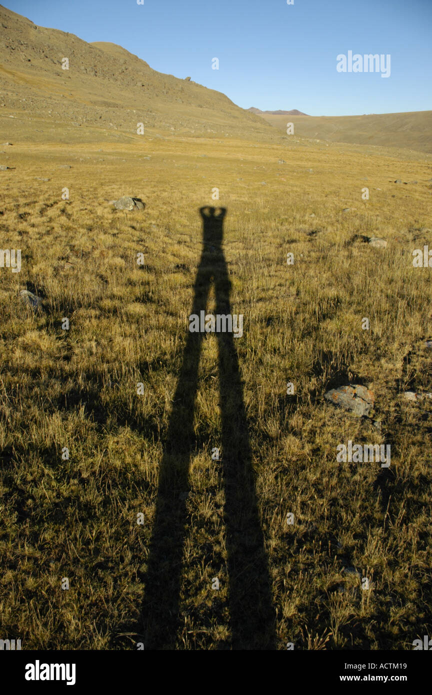 Shadow of a person with extrem long legs in the steppe Kharkhiraa ...