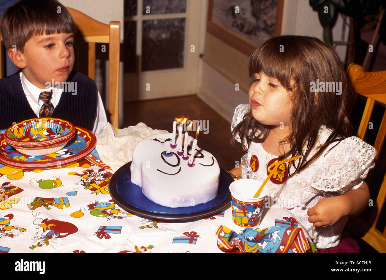 Four Year Olds Birthday Blowing Out Candles On Casper Cake - England ...