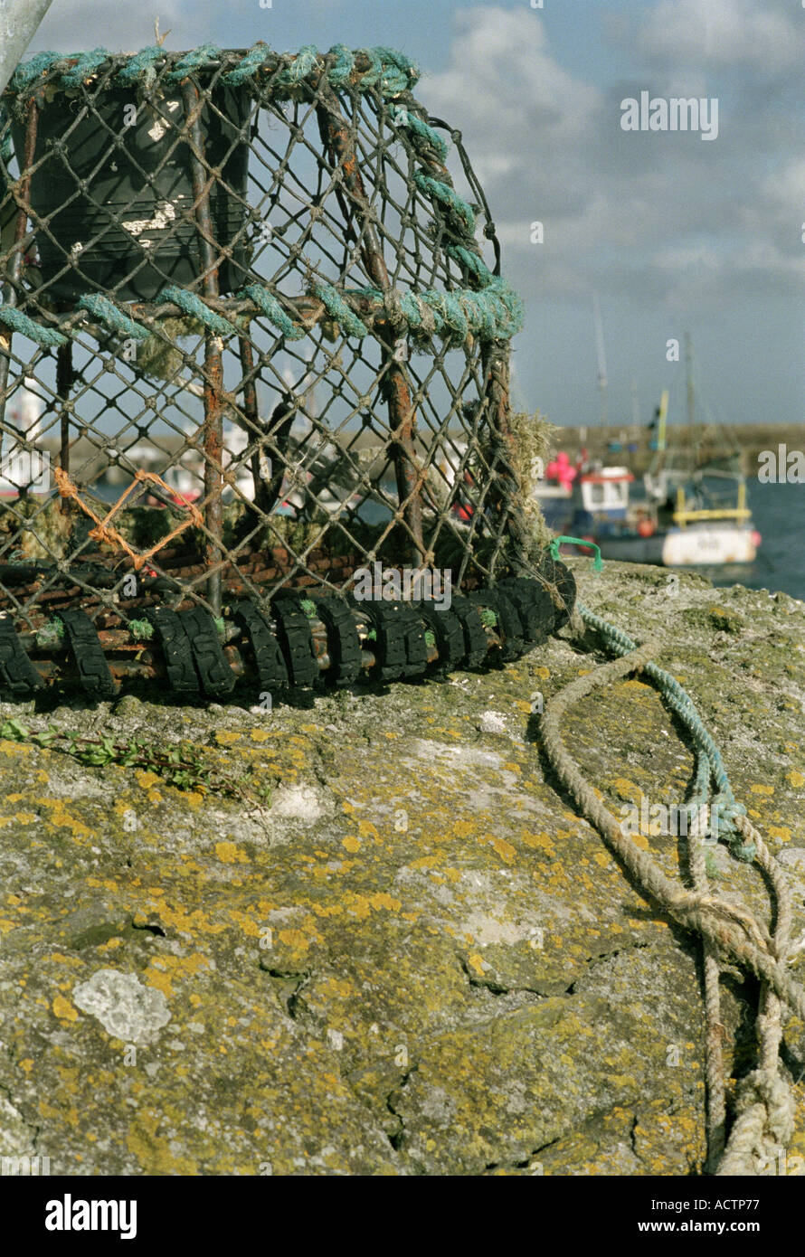 Lobster pot on the quayside and harbour wall of Mevagissey, Cornwall ...