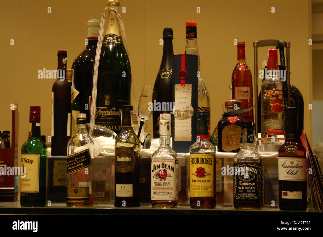 Bottles of spirits lit from above Stock Photo - Alamy