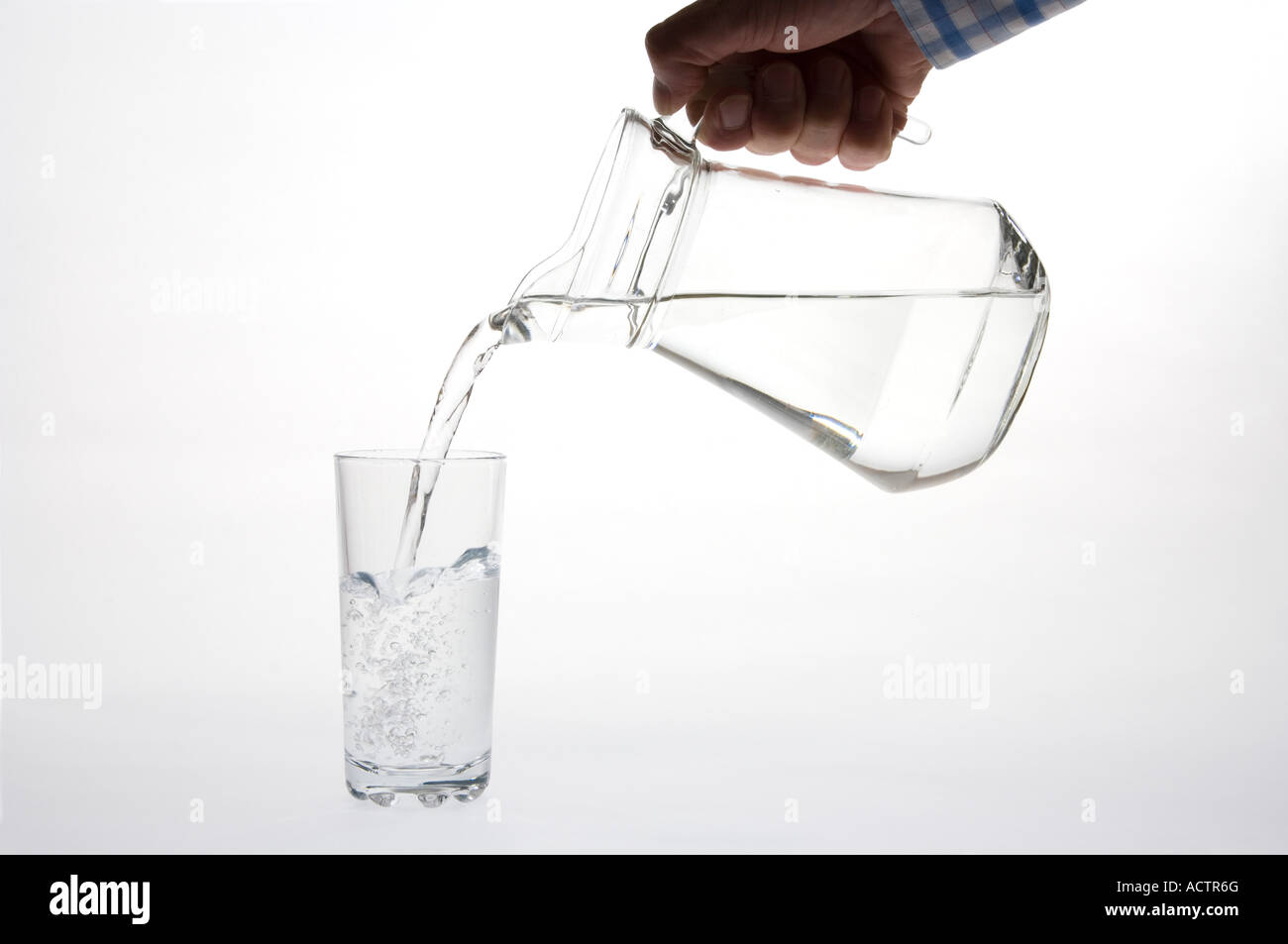 Pure clean drinking water being poured from a jug into a glass (large ...