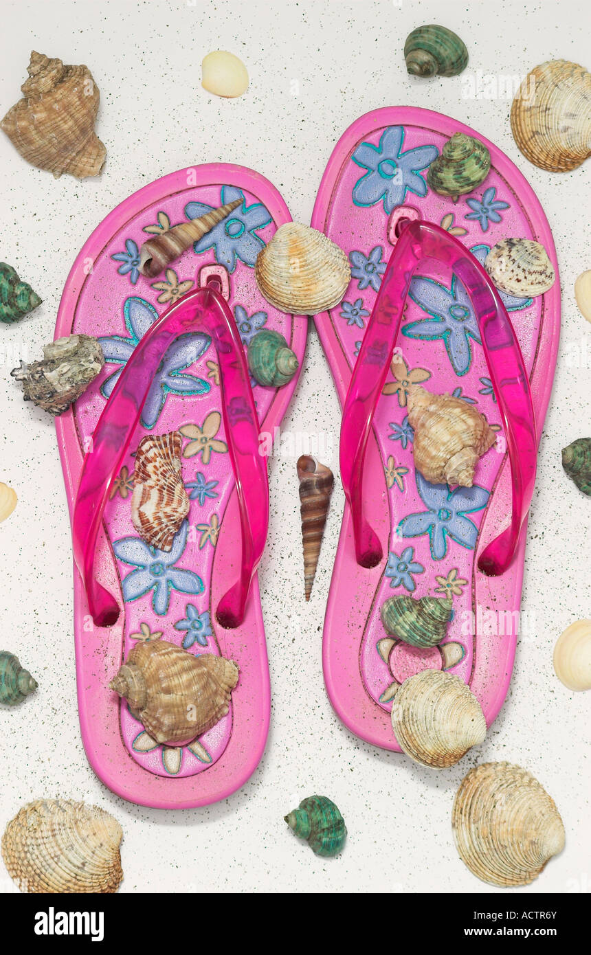 Pair of pink flip flops and sea shells close up Stock Photo - Alamy
