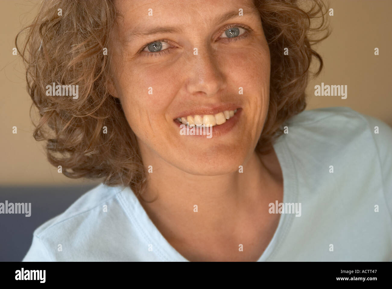 Blond woman friendly looking Stock Photo - Alamy