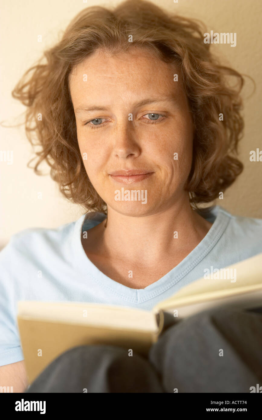 Blond woman reads a book Stock Photo - Alamy