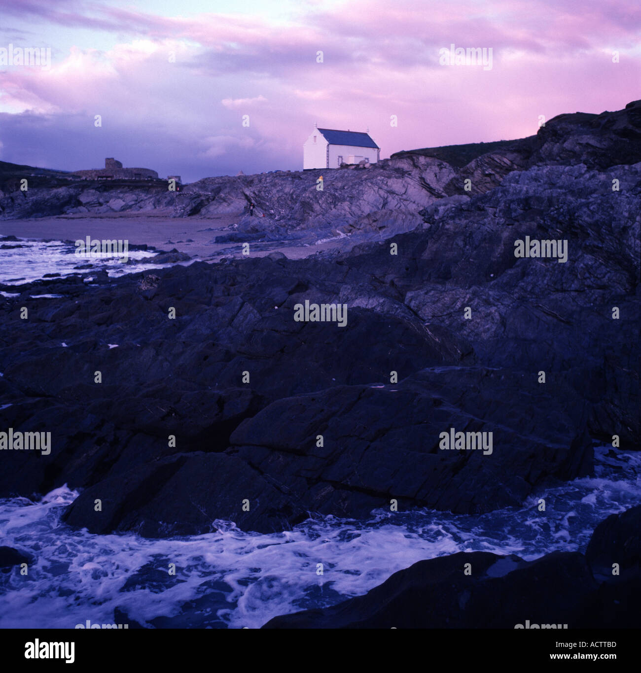 Small cliff top cottage at sunset along the Cornish coastal path in ...