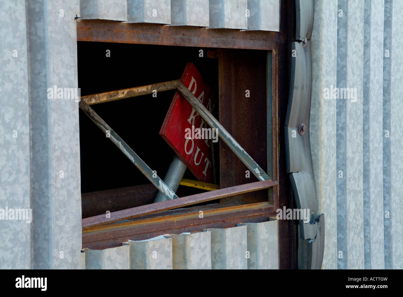 A CLOSED FACTORY BUILDING'S WINDOW WITH A SIGN SAYING DANGER KEEP OUT ...