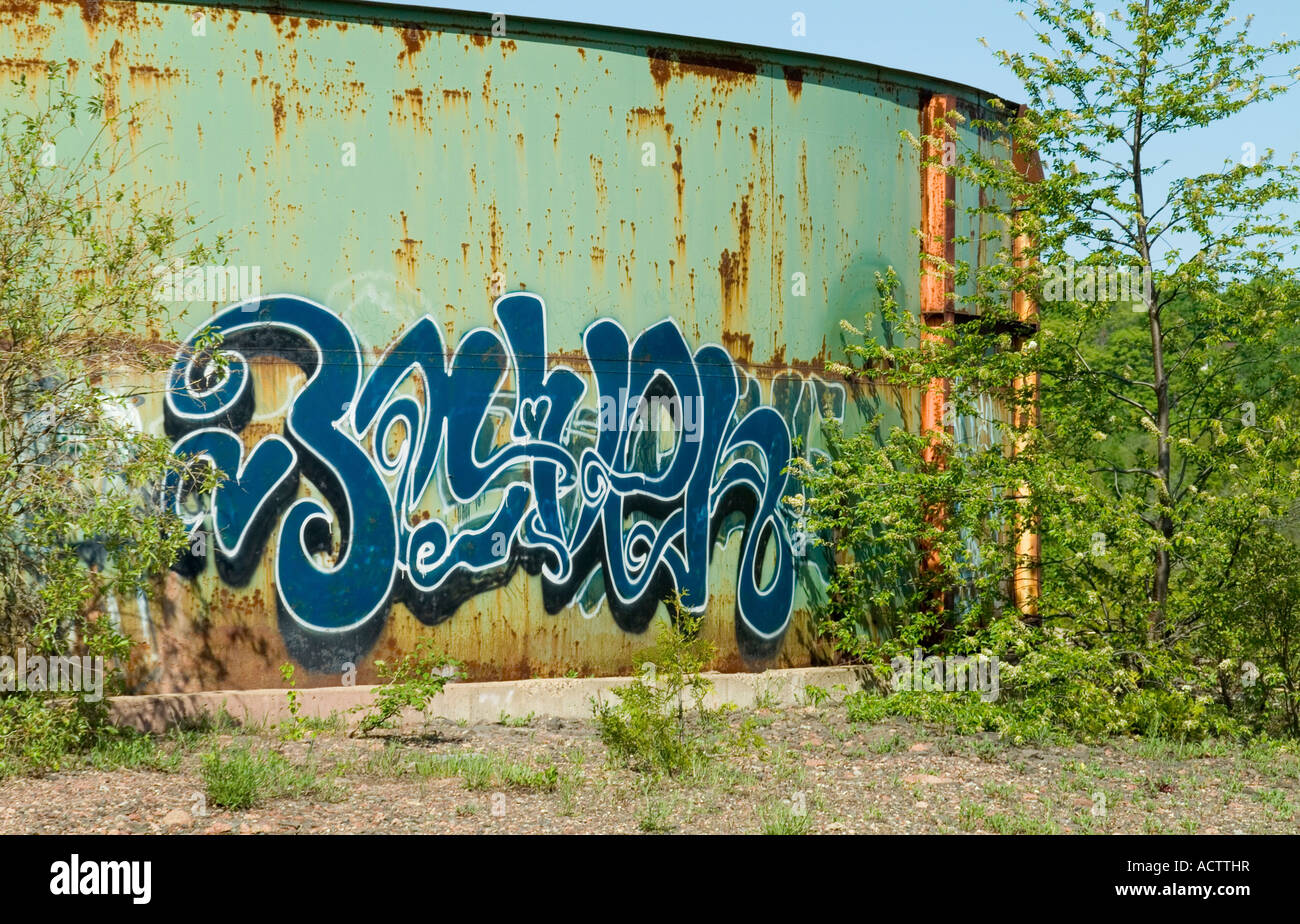 BIG ROUND OLD WATER TANK WITH BLUE GRAFFITI Stock Photo - Alamy