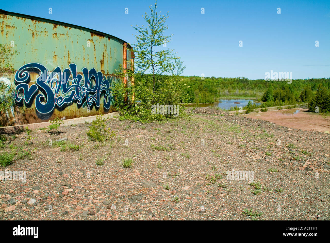 BIG ROUND OLD WATER TANK WITH BLUE GRAFFITI Stock Photo - Alamy