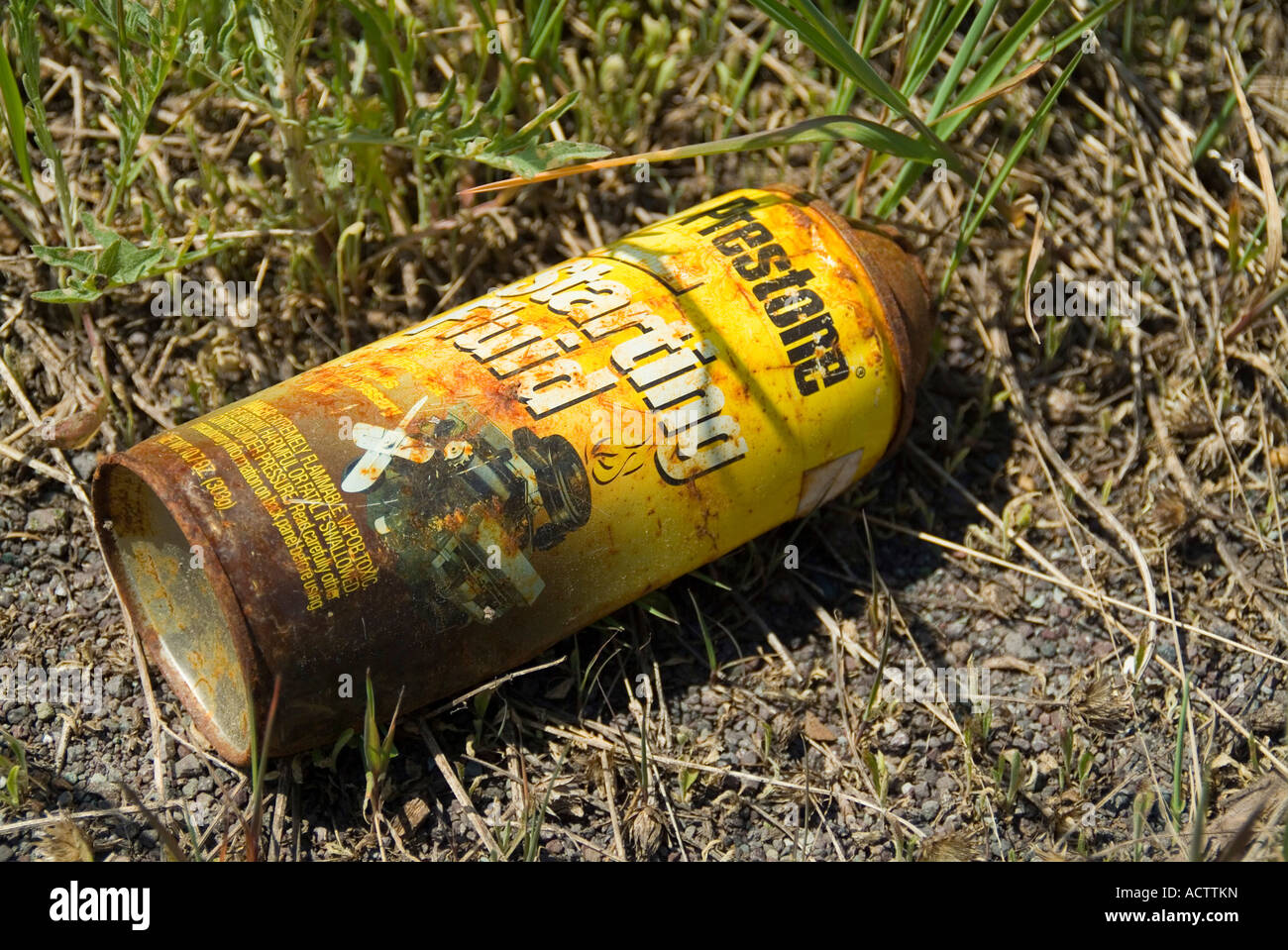 AN OLD RUSTY CAN OF STARTING FLUID LAYING IN THE FIELD Stock Photo - Alamy
