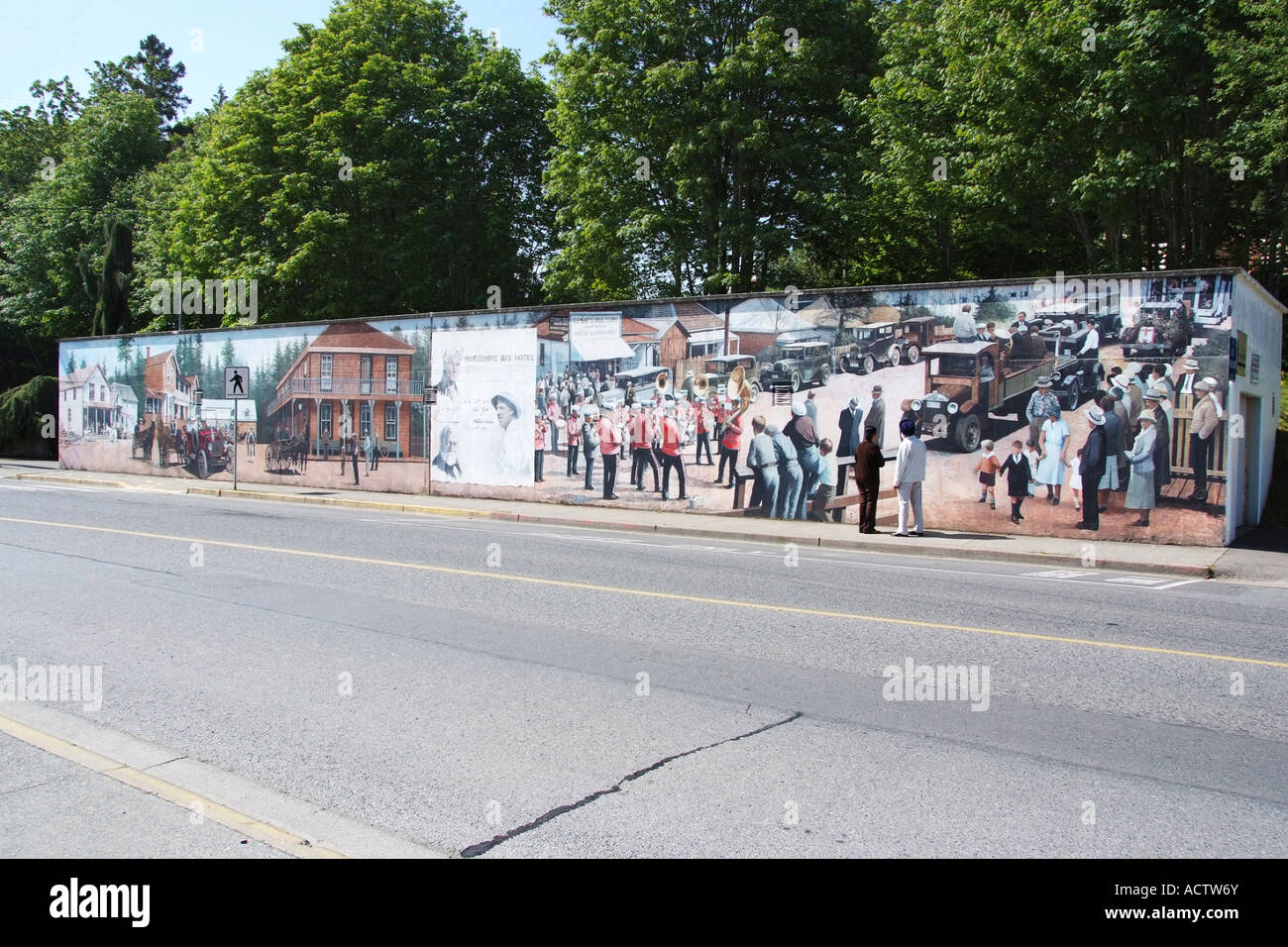 A HUSBAND AND WIFE COUPLE IS WATCHING A WALL MURAL OF PARADE SHOW AND ...