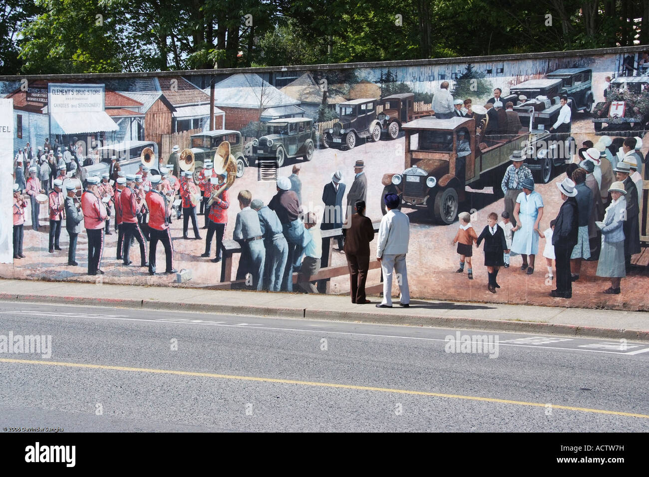 A HUSBAND AND WIFE COUPLE IS WATCHING A WALL MURAL OF PARADE SHOW AND ...