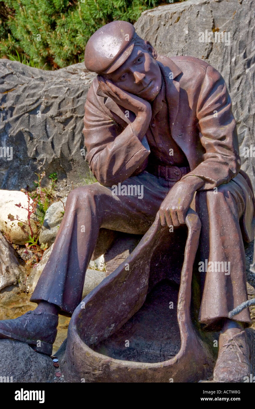 STATUE OF A EARLY 20TH CENTURY POSTMAN RESTING HIS HEAD ON HIS HAND ...