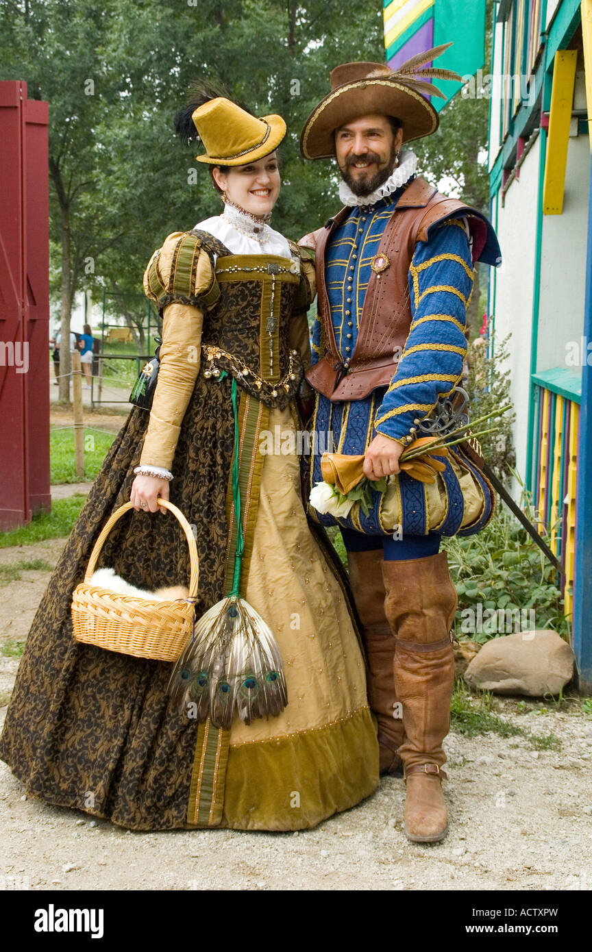 FULL BODY PORTRAIT VIEW OF YOUNG COUPLE DRESSED IN MEDIEVAL CLOTHES AND ...