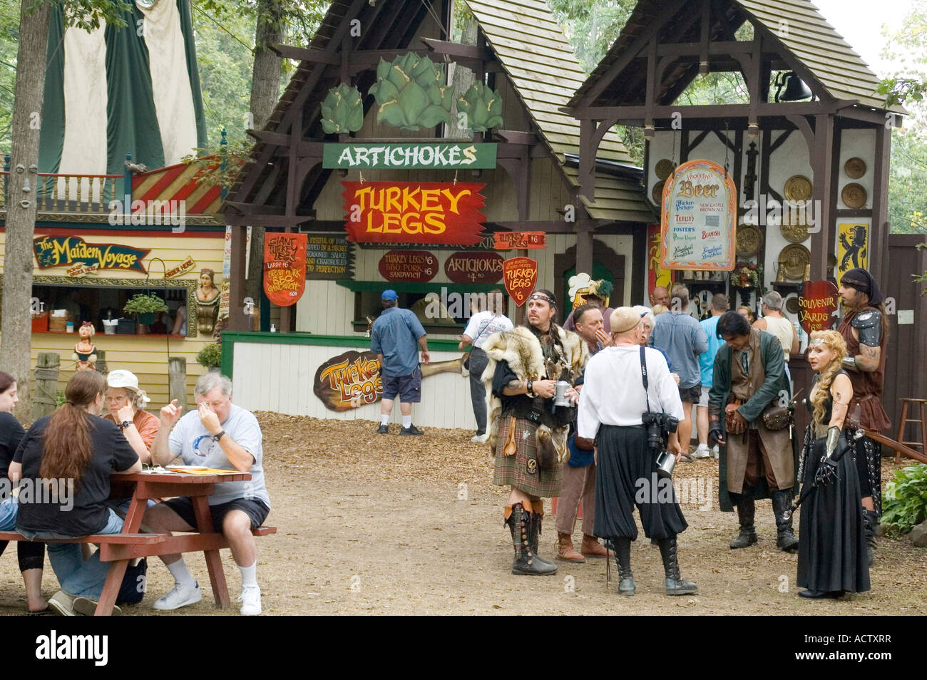 STREET SCENE OF PEOPLE DRESSED IN MEDIEVAL DRESSES AT RENAISSANCE FAIR ...