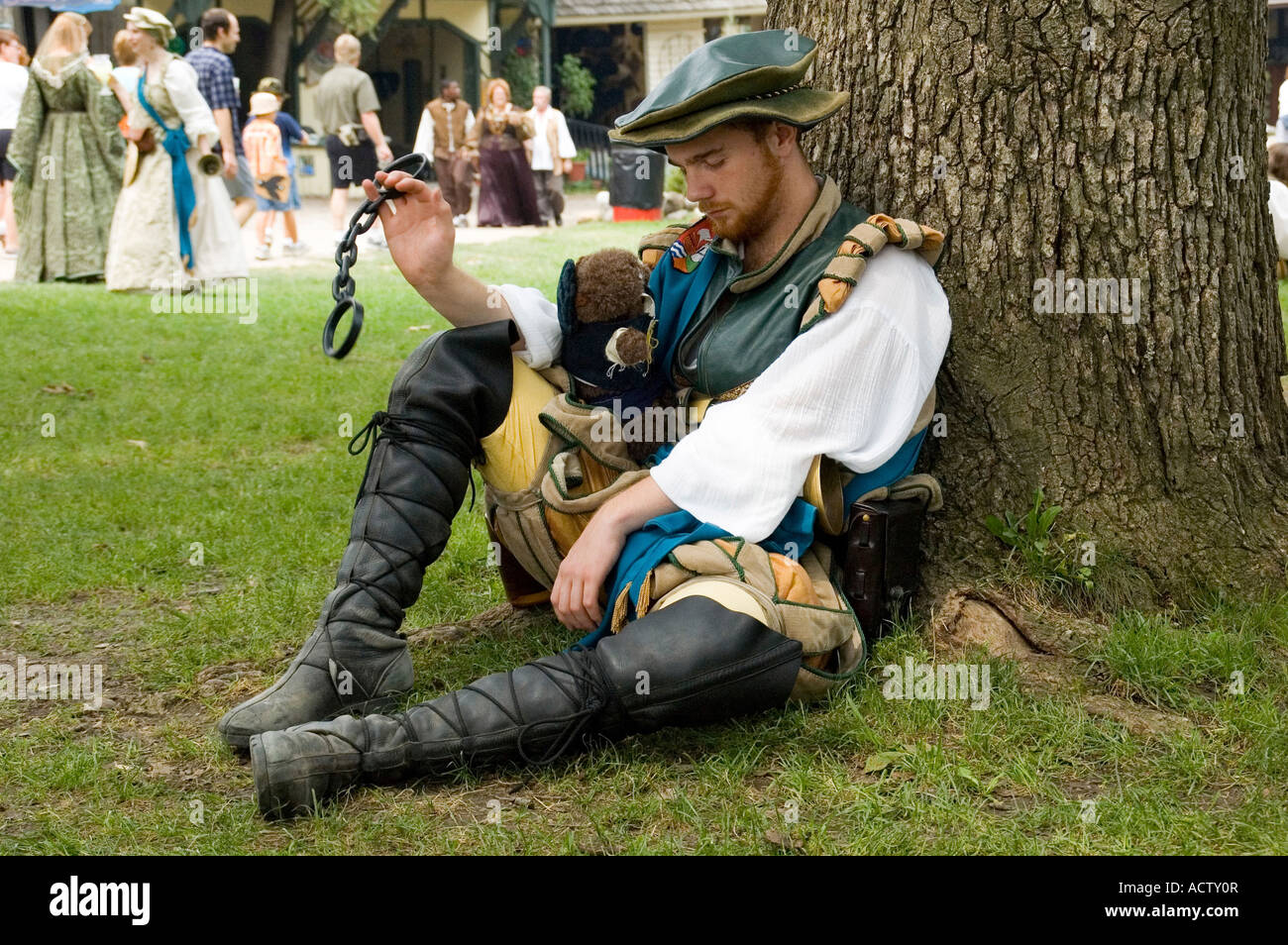 A young man resting under a tree Stock Photo - Alamy