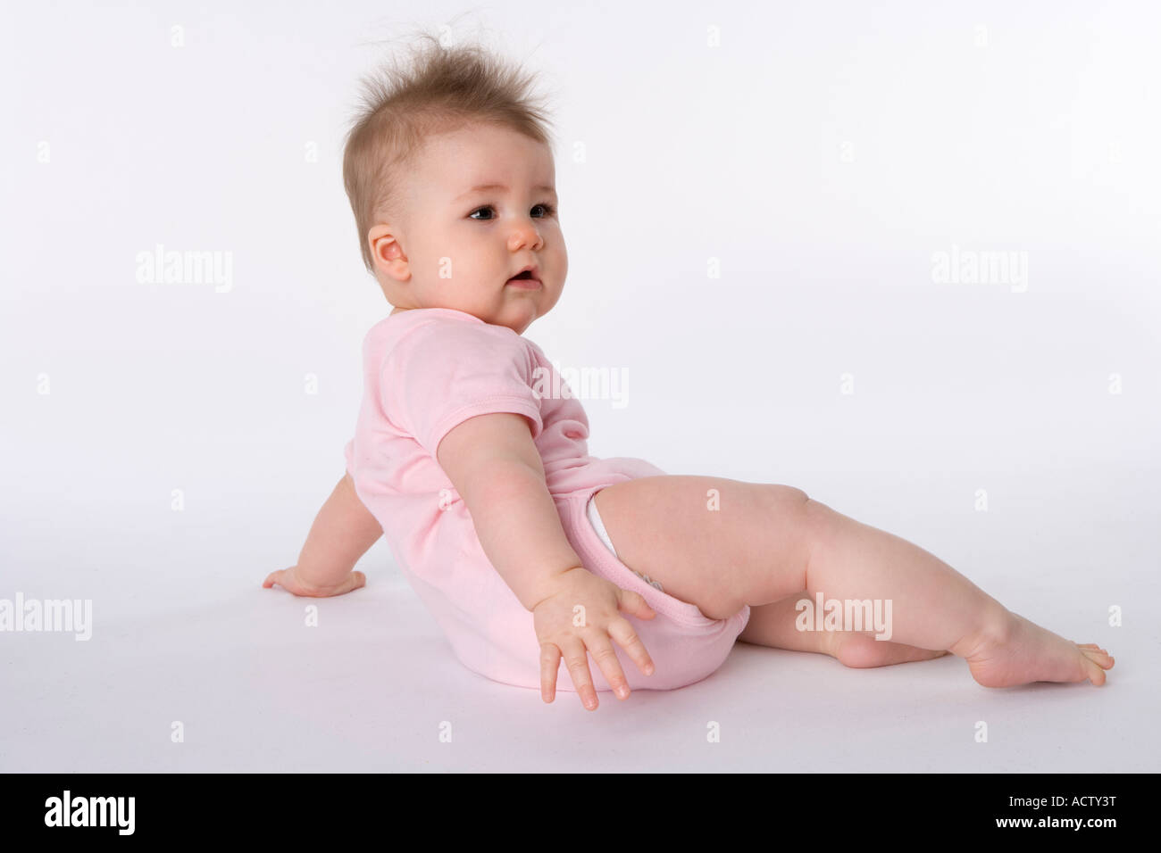 Baby lying on the floor with a surprised expression Stock Photo - Alamy