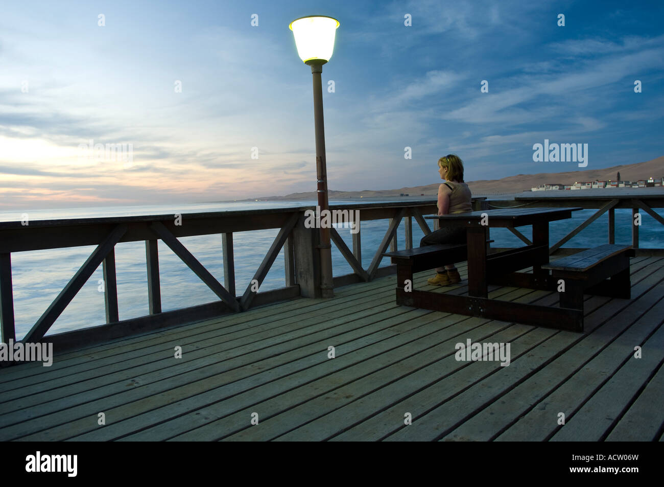 Woman sitting looking out to see Long Beach Namibia Stock Photo - Alamy