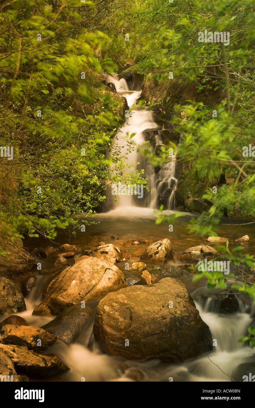 waterfall with large foreground rock Stock Photo - Alamy