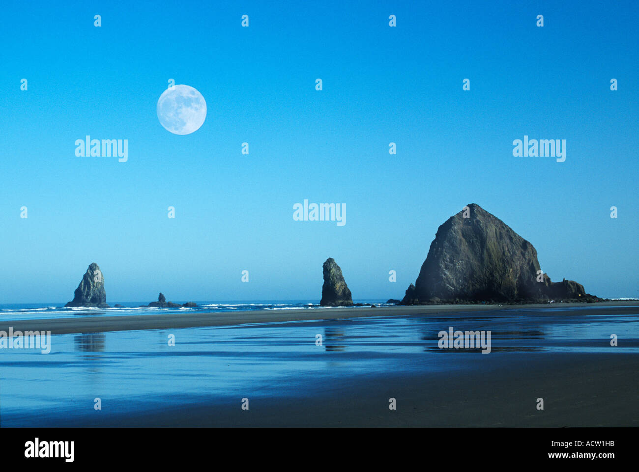 The haystack rock formations with full moon at Canon Beach Oregon USA ...