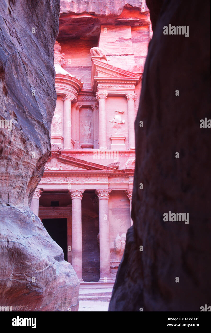 An opening in the rock crevice framing the Treasury building in the ...