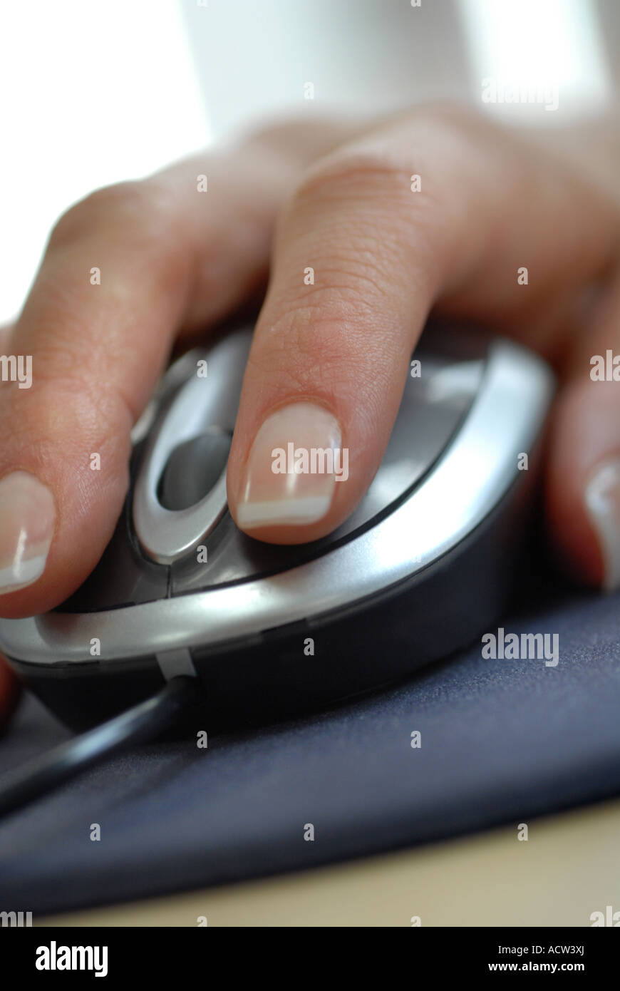 Womans hand using a computer mouse with scroll wheel in an office Stock ...