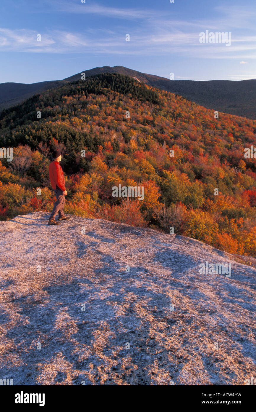 Hiker on granite ledge in autumn, White Mountain National Forest, New ...