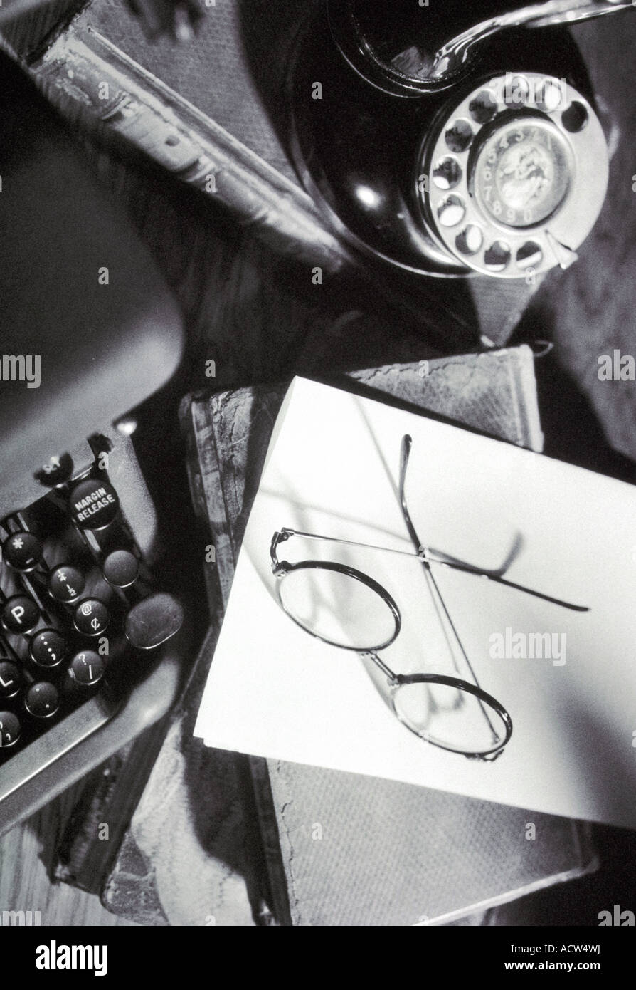 Old typewriter on desk books phone glasses horizontal Stock Photo - Alamy