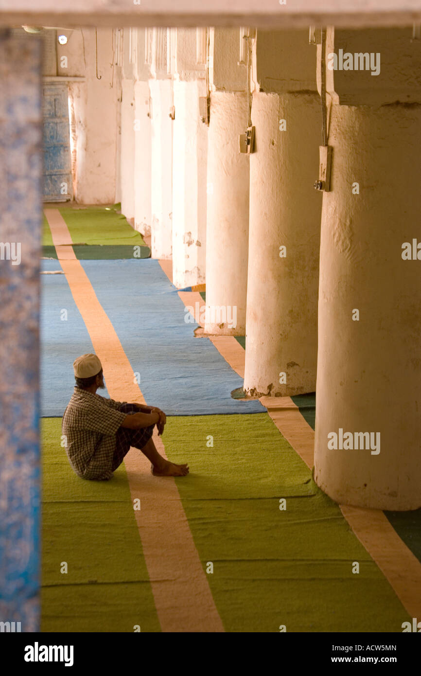 Man praying inside a peaceful mosque in the Unesco World Heritage town ...