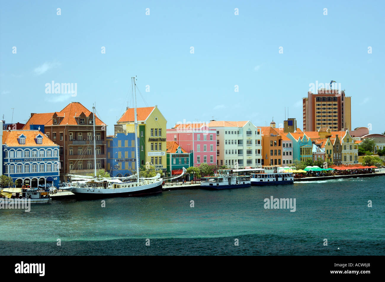 The brightly colored buildings with Dutch colonial architecture line ...