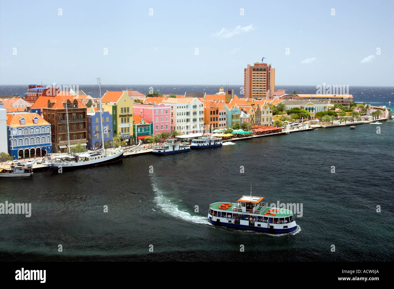 The brightly colored buildings with Dutch colonial architecture line ...