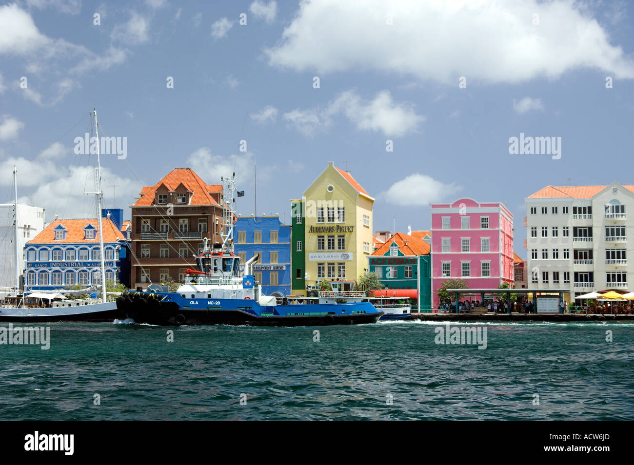 The brightly colored buildings with Dutch colonial architecture line ...