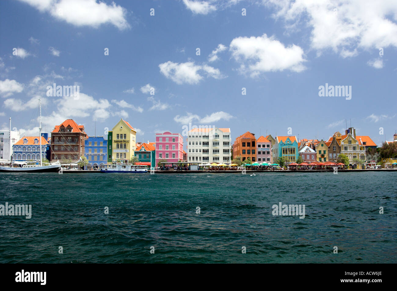 The brightly colored buildings with Dutch colonial architecture line ...