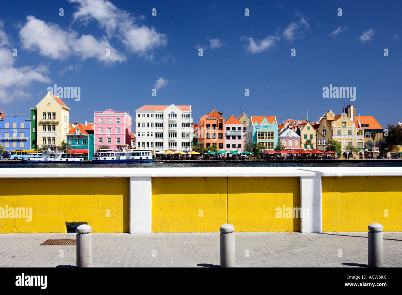 The brightly colored buildings with Dutch colonial architecture line ...