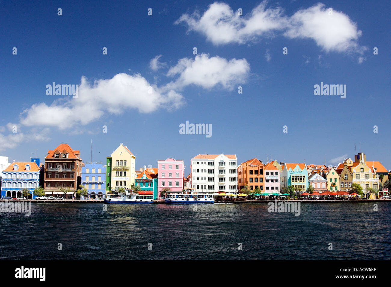 The brightly colored buildings with Dutch colonial architecture line ...